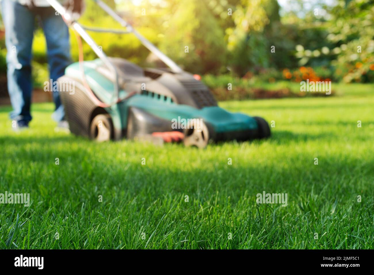 Man pushing mower hi-res stock photography and images - Alamy