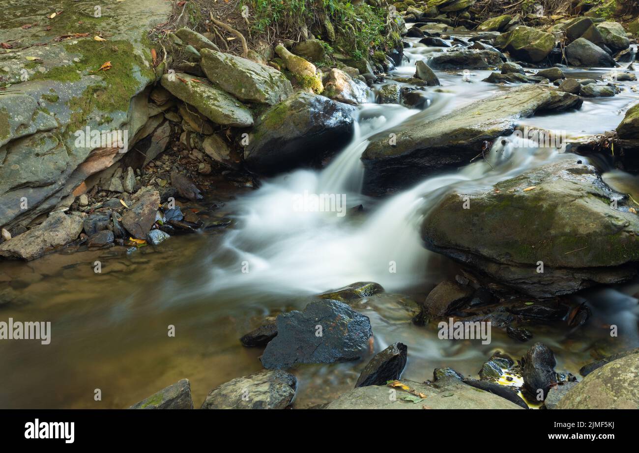 Fast running stream water cascading over boulders in an area near Boone ...