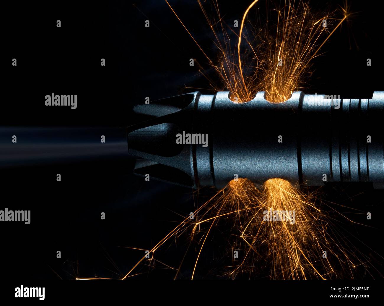 Sparks fand smoke coming from the barrel of a rifle on a black ...