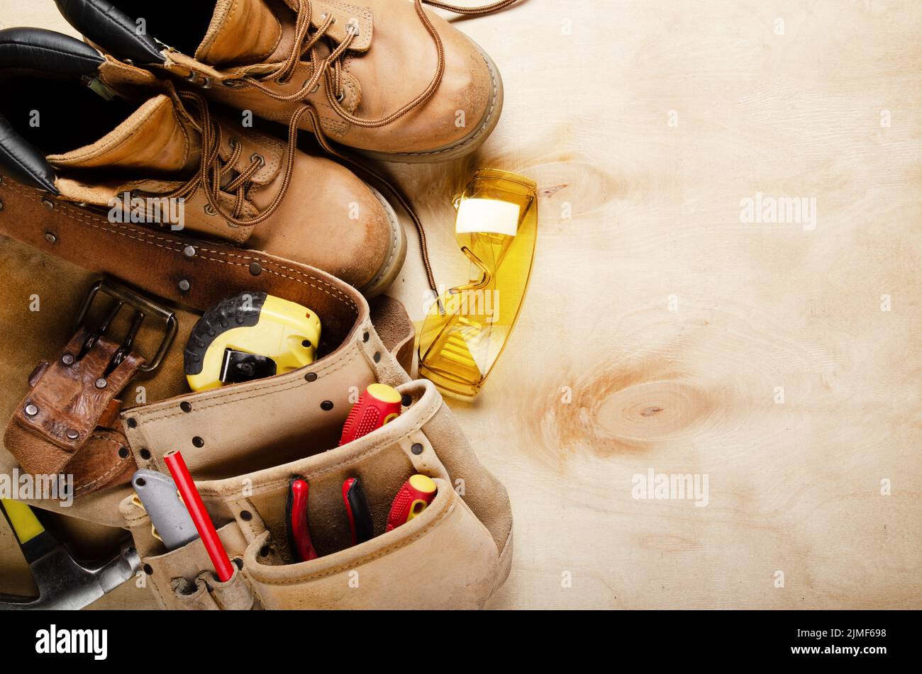 Construction concept background of toolbelt yellow boots goggles ant ...