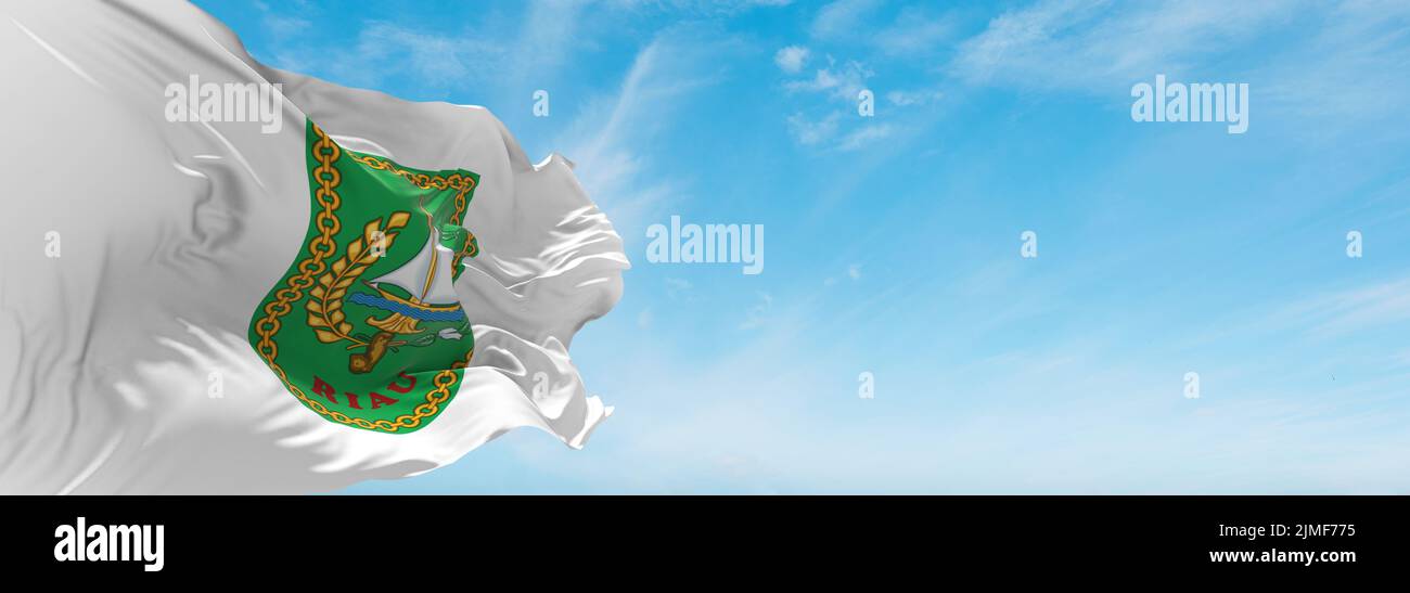 official flag of Riau Indonesia at cloudy sky background on sunset ...