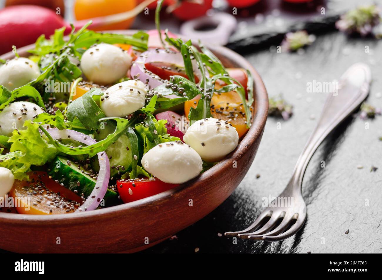 Vegetable salad with mozzarella cheese, lettuce, cherry tomatoes ...
