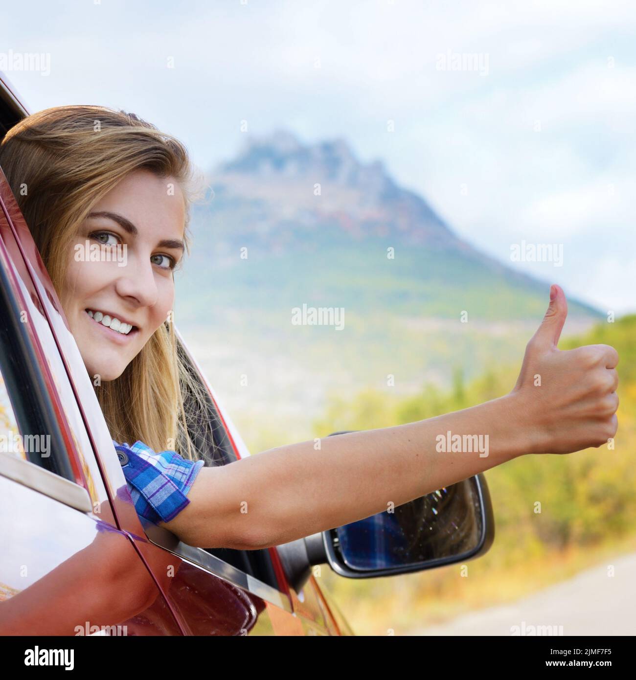 Happy driver woman shows thumb up Stock Photo - Alamy