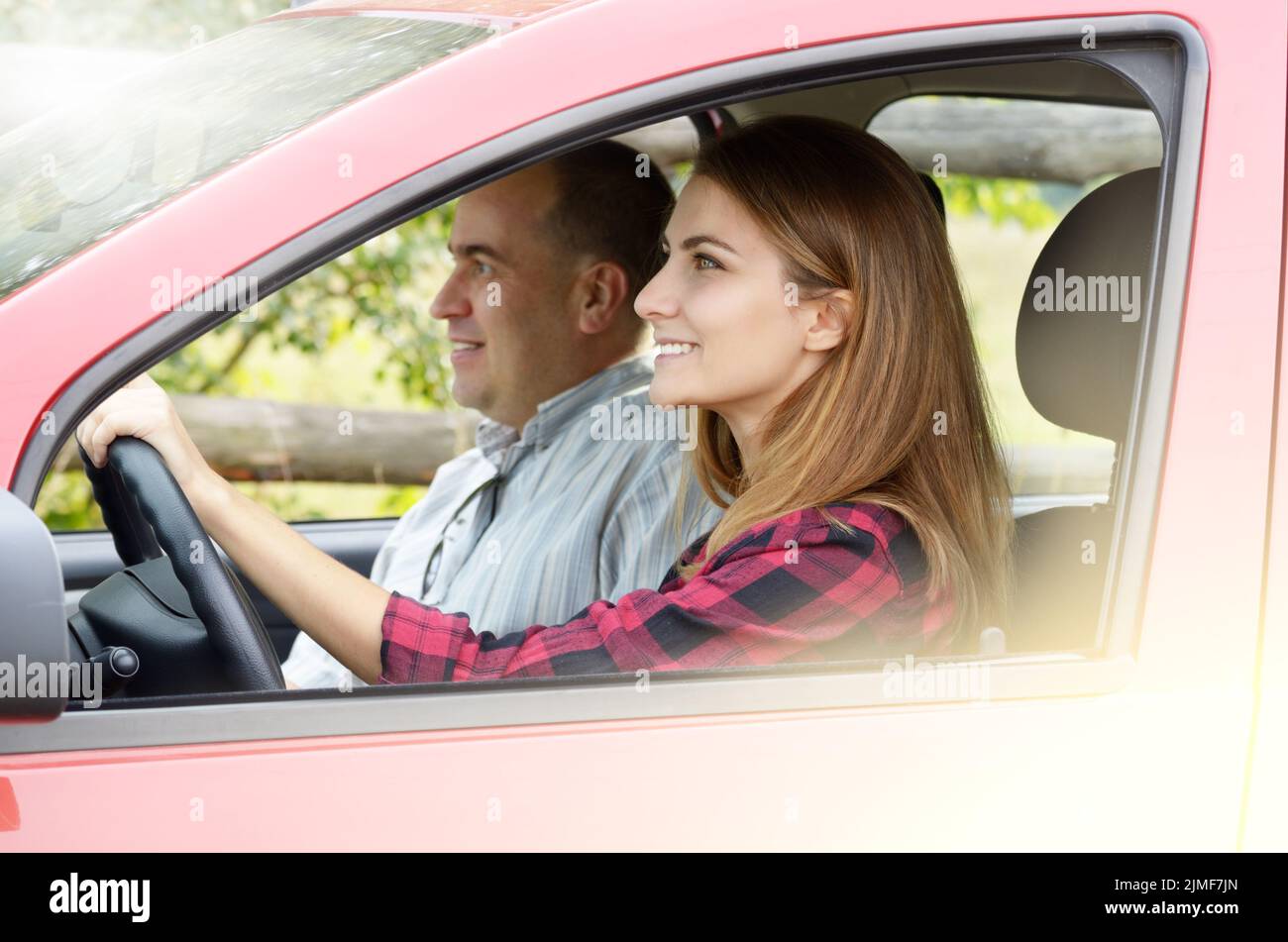 Young woman takes driving lesson Stock Photo - Alamy