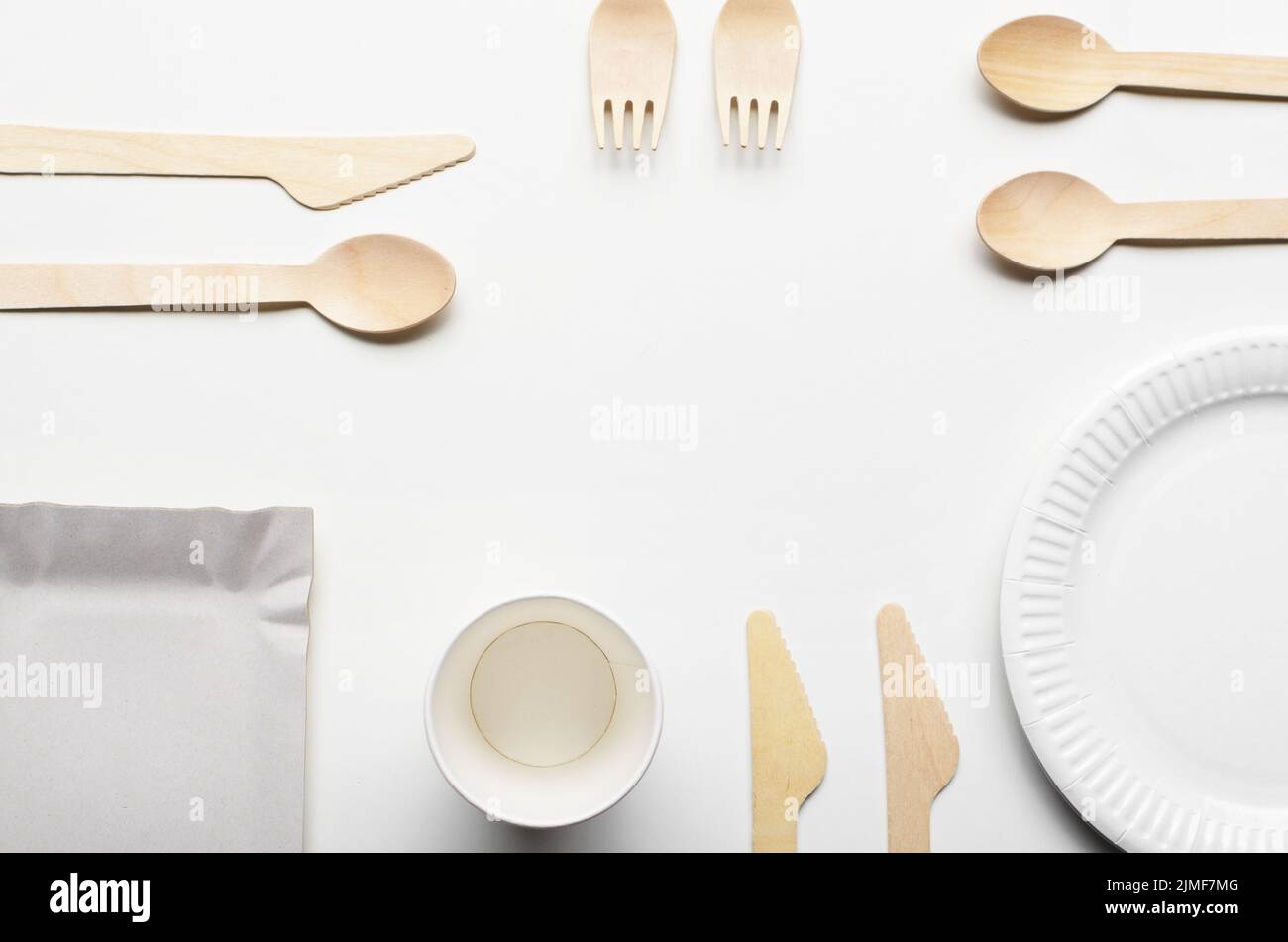 Wooden single use kitchenware and paper cups and plates on white. Top ...