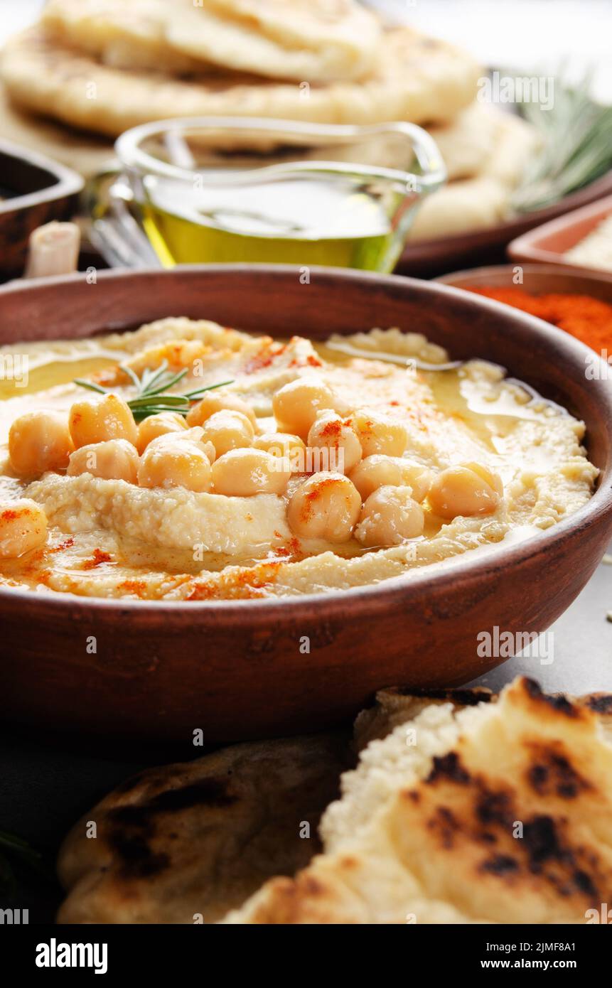 Low angle view at Hummus topped with chickpeas, olive oil and green ...
