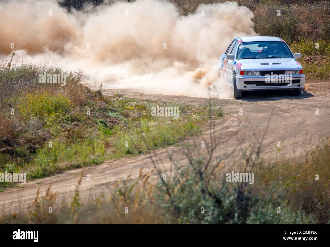 Lot of Dust on a Sharp Bend From a Rally Car Stock Photo - Alamy