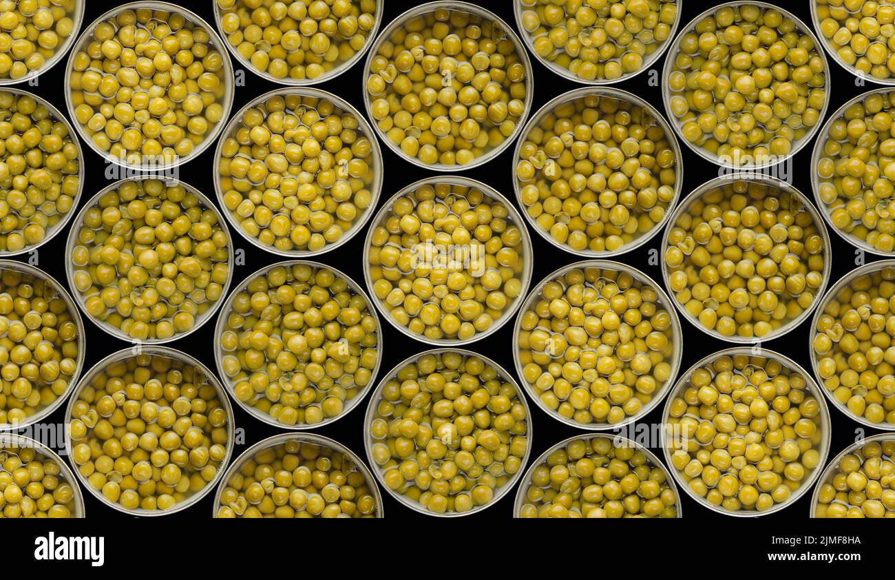 Seamless background of flat lay opened tin cans with green peas ...