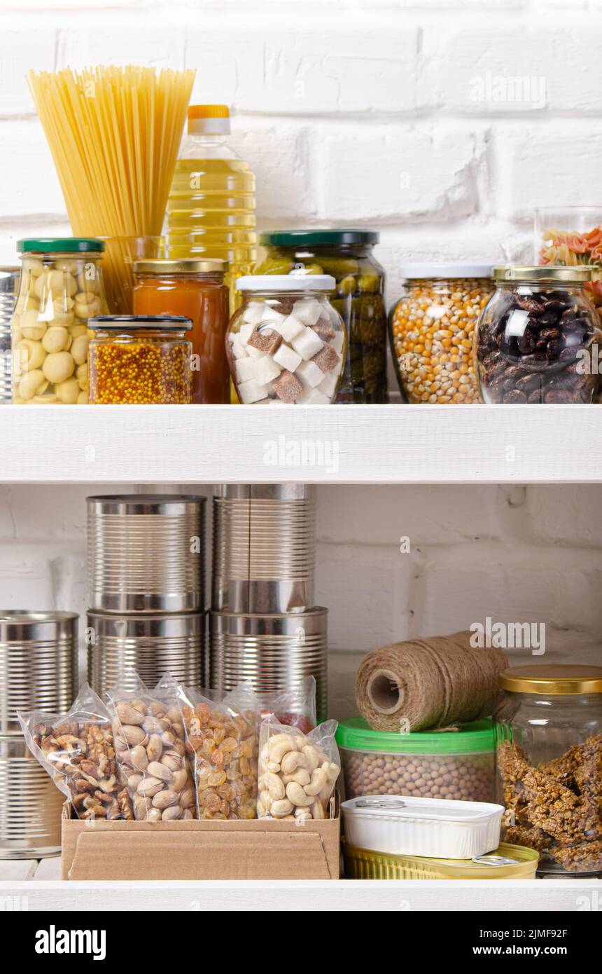 Set of non-perishable foods on pantry shelf on brick wall background ...