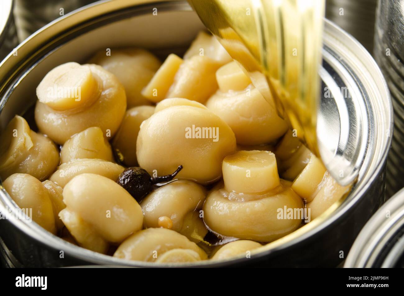 Canned button mushrooms in just opened tin can. Non-perishable food ...