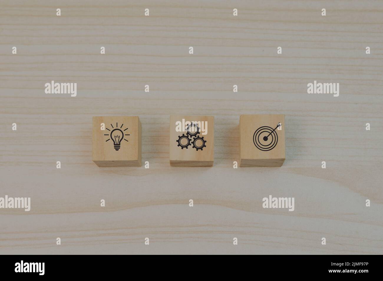Strategy goals and investment plan business marketing icon symbol gear and light bulb with wood ...