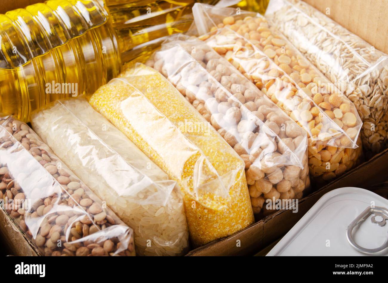 Set of uncooked foods in carton box prepared for emergency conditions ...