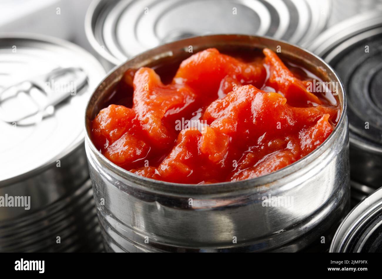 Canned sliced tomatoes in just opened tin can. Non-perishable food ...
