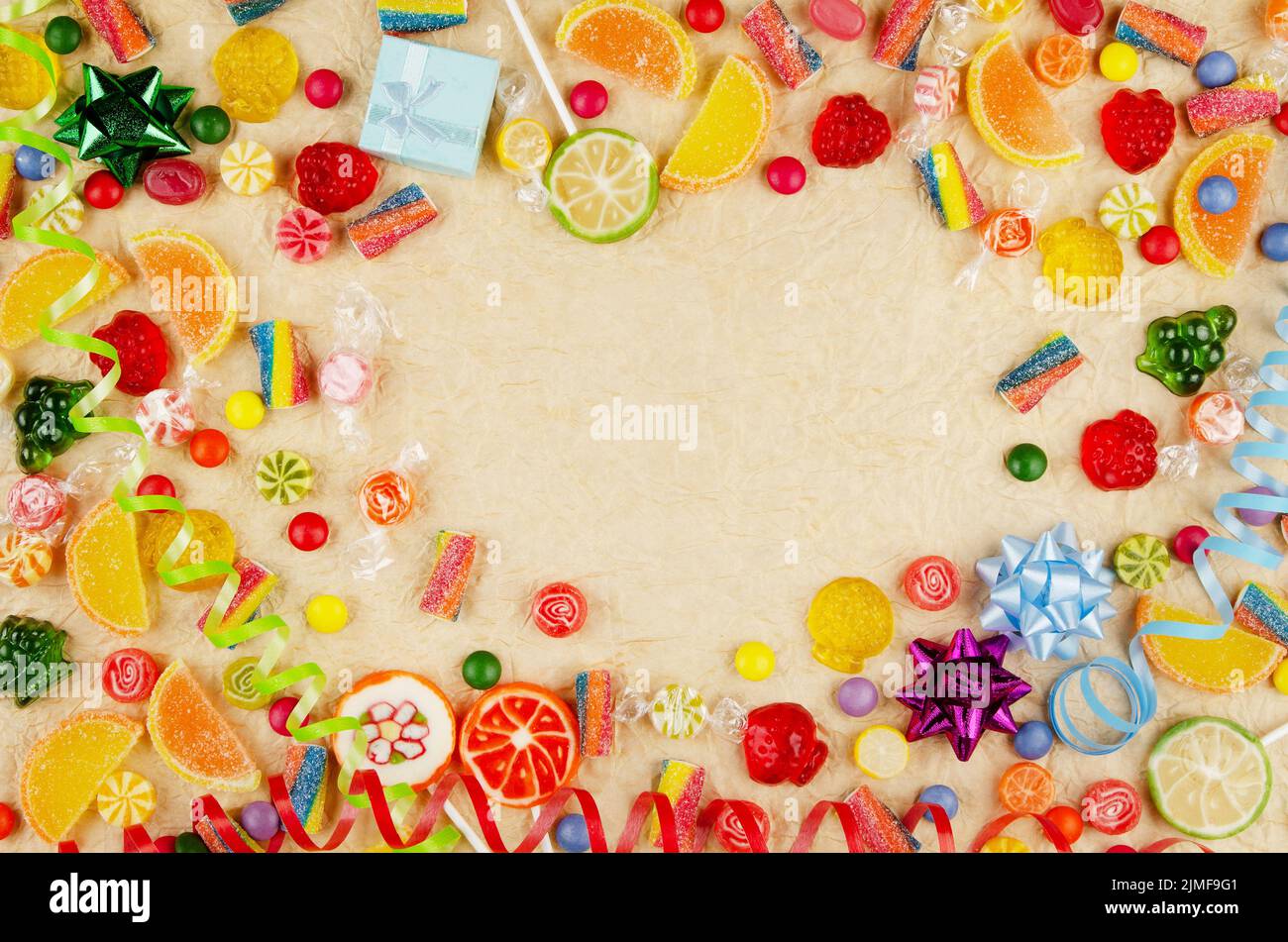 Flat lay view at frame made of different type color and taste candies ...