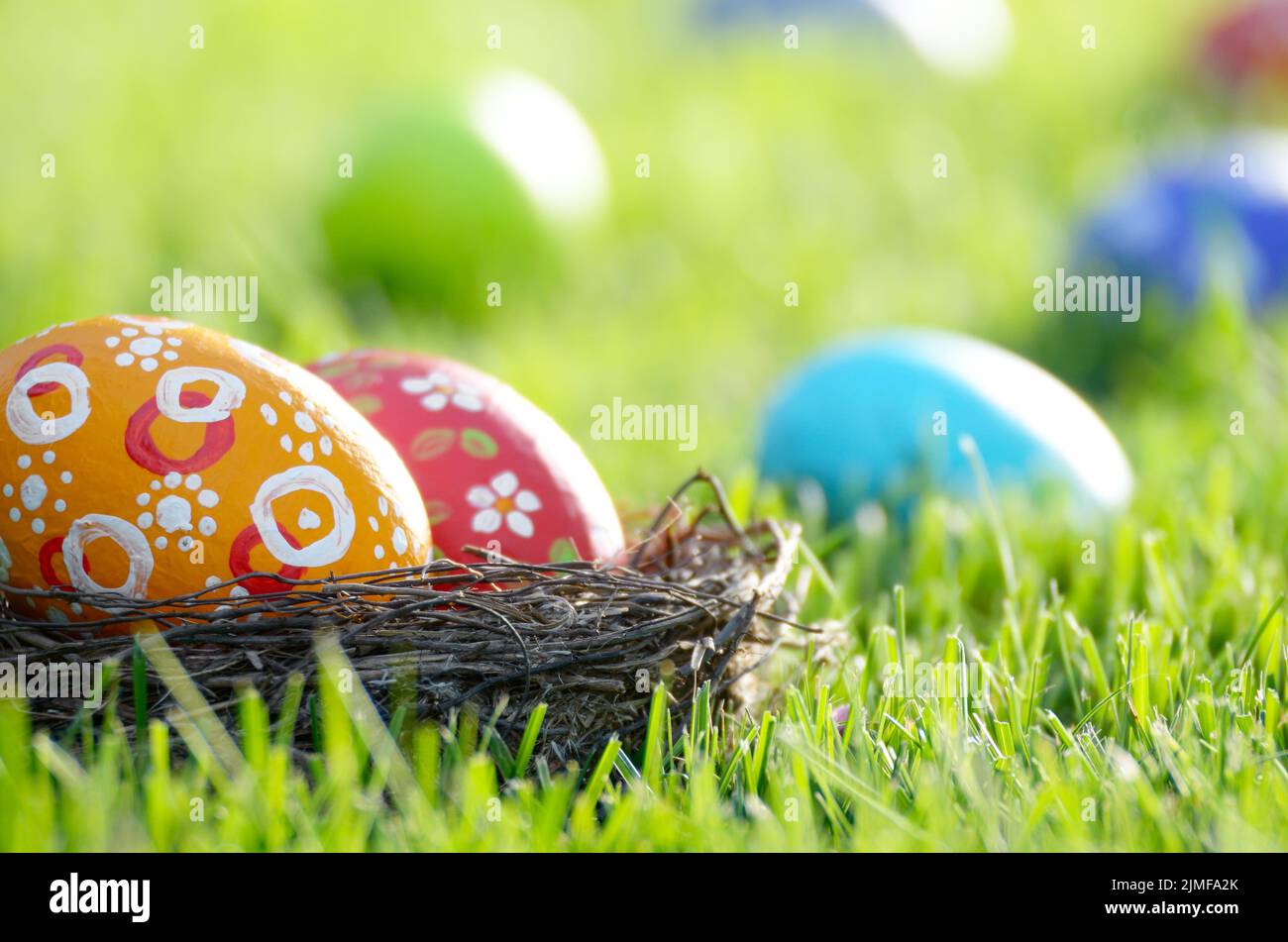 Easter eggs in the nest on green spring grass Stock Photo - Alamy