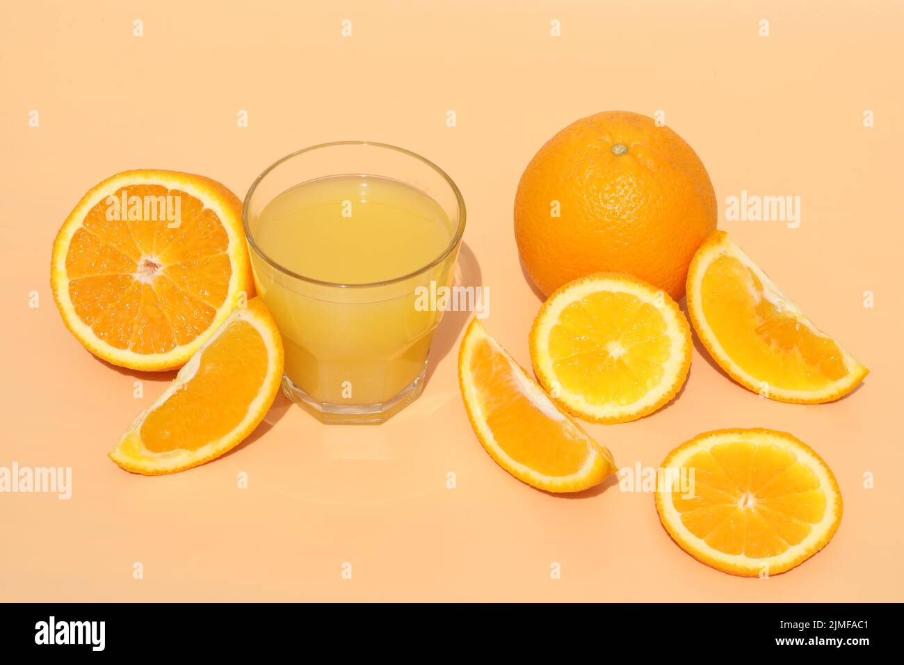 fresh bright orange juice with oranges on yellow background Stock Photo ...