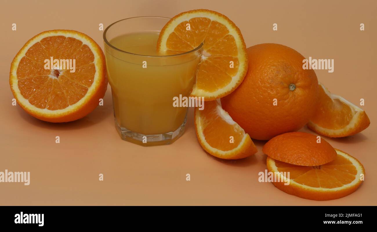fresh bright orange juice with oranges on yellow background Stock Photo ...