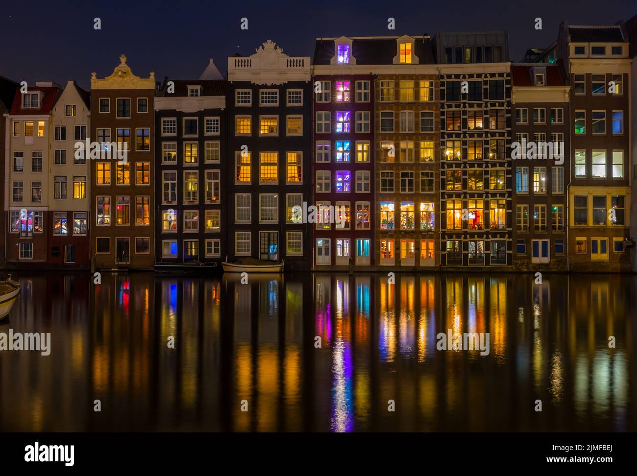 Dancing Houses on the Amsterdam Canal at Night Stock Photo - Alamy