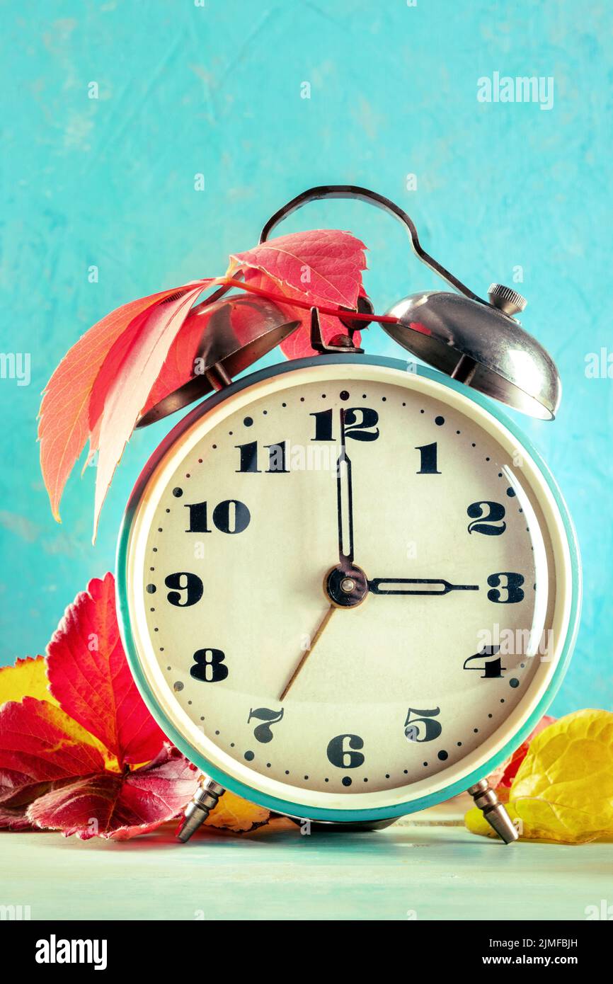 Daylight Savings Time concept, fall back in autumn. A vintage alarm ...