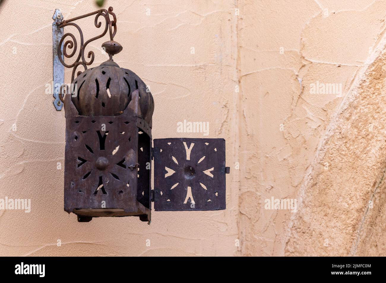 Arabic style lamp on the wall of a typical middle eastern architecture style building with ...