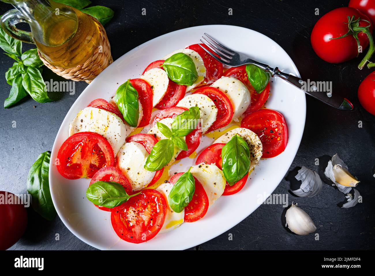 Tomato with mozzarella and basil Stock Photo - Alamy
