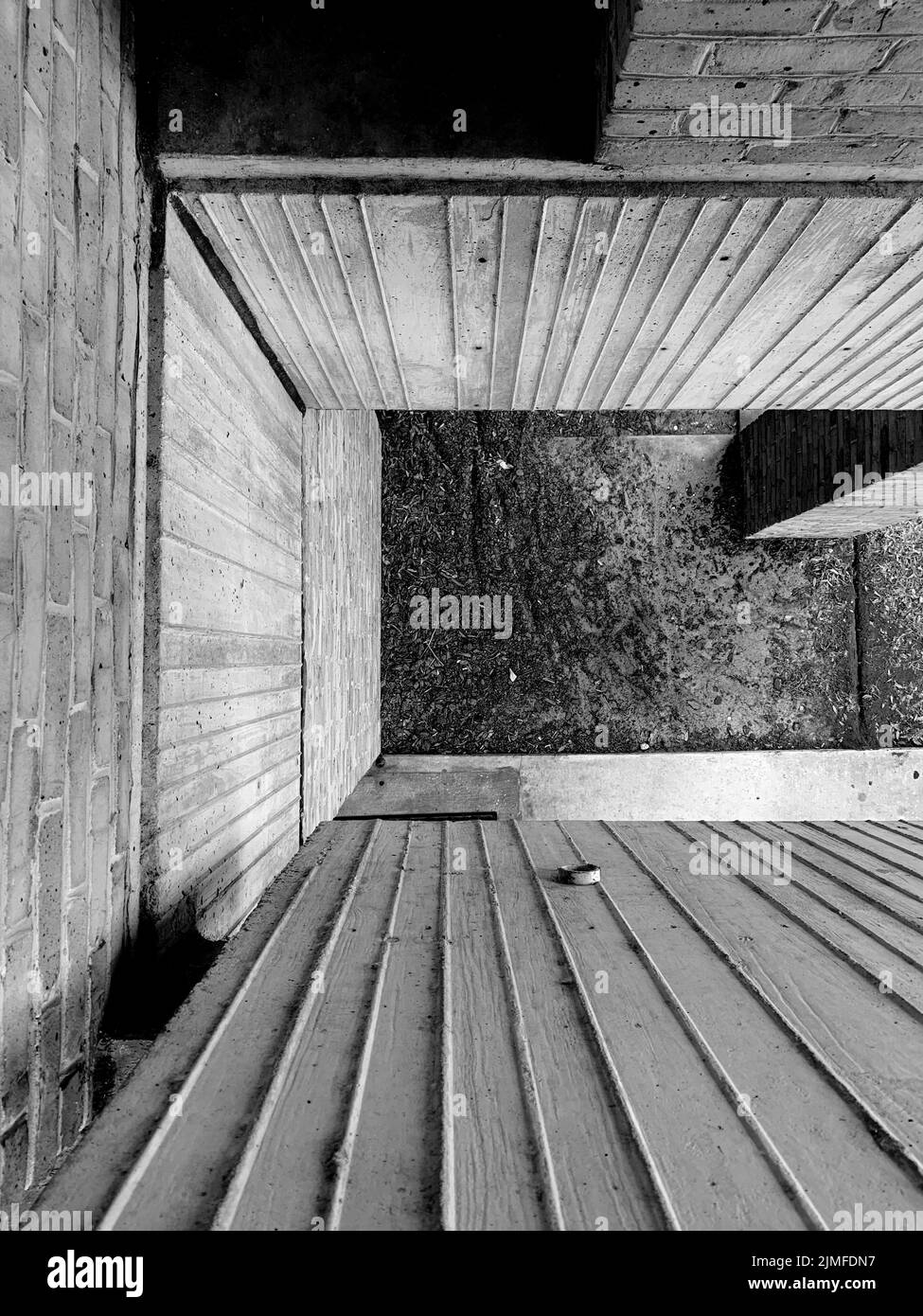 A vertical grayscale top view of the floor from a building balcony ...