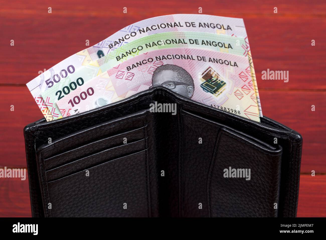 Angolan money in the black wallet Stock Photo - Alamy