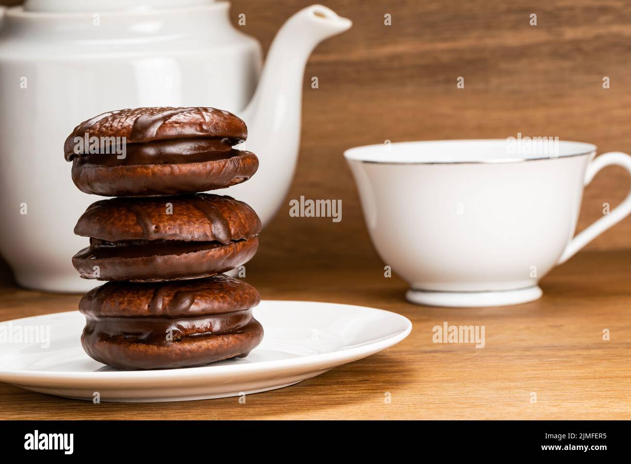 Closeup view stack of choco pie and a cup of hot tea Stock Photo - Alamy