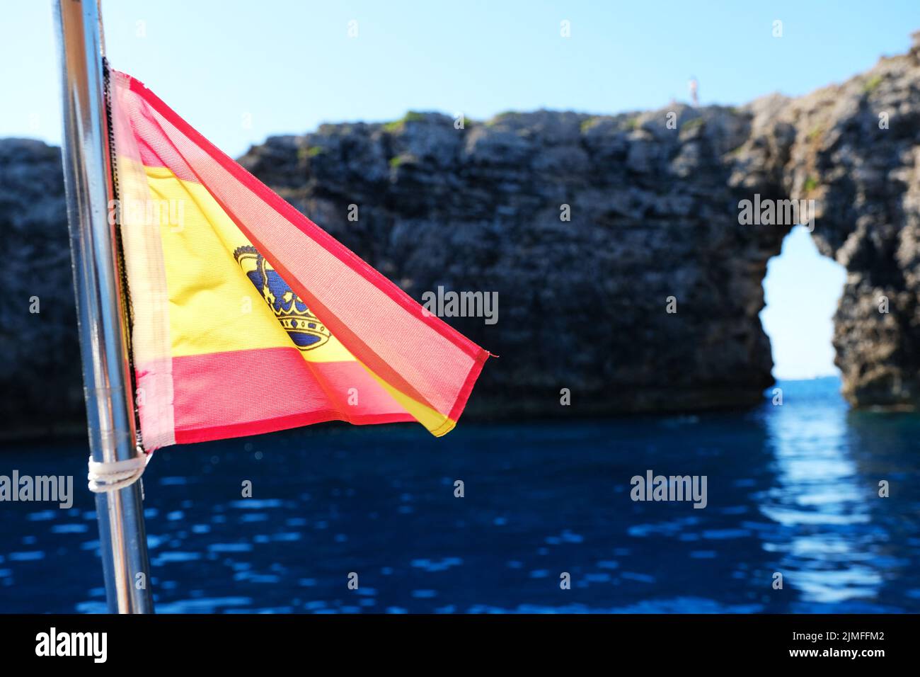 The Spanish royal crown flag on a boat in Pont de Gil, Mediteraneen sea ...