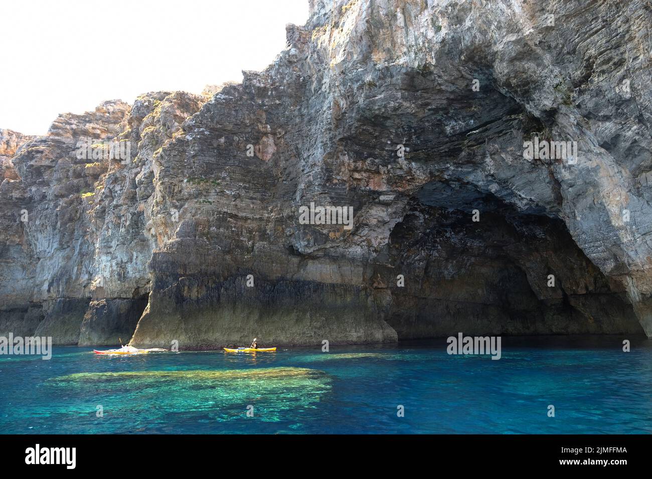A young woman is swimming in Pont de Gil, mediterraneen sea in Menorca ...