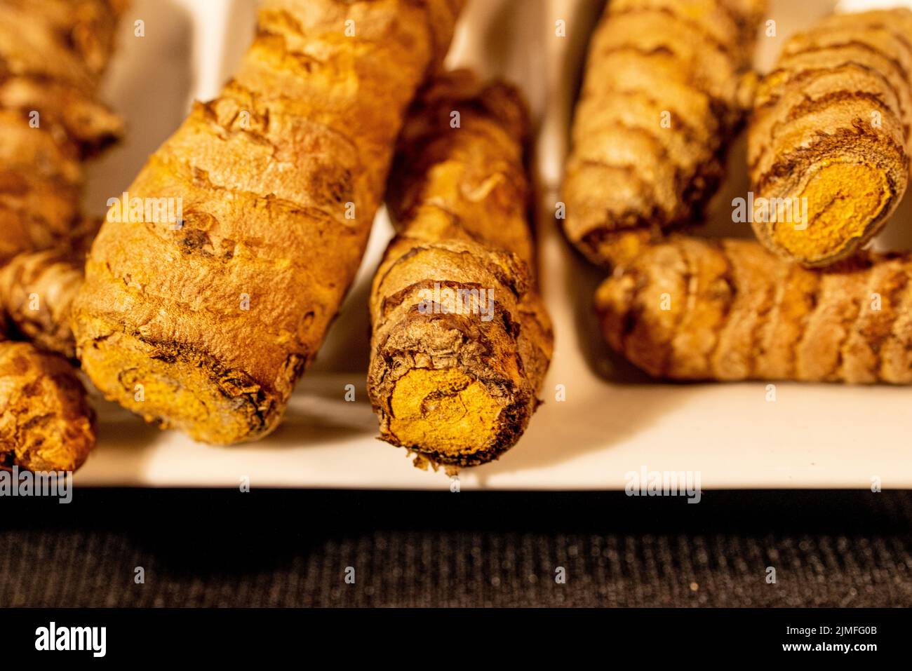 Ginger Roots on a dark background Stock Photo - Alamy