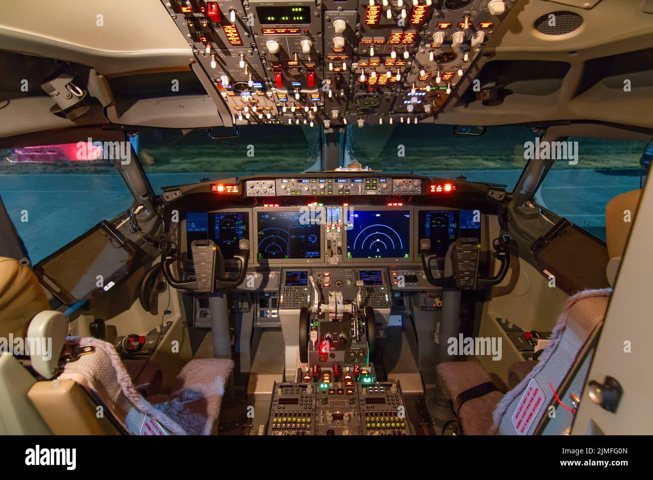 A view of the cockpit of a large commercial airplane a cockpit ...