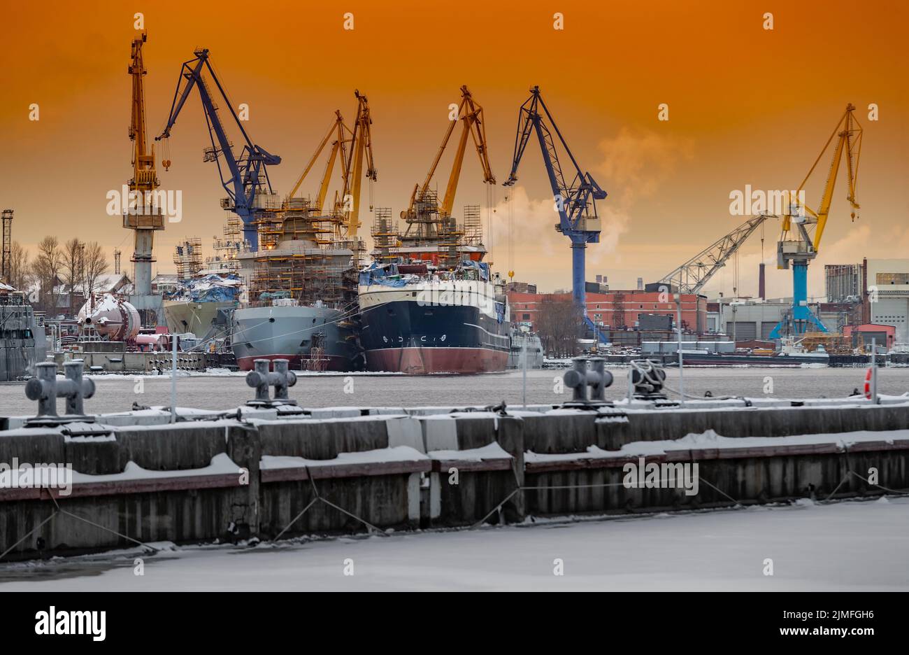 The construction of nuclear icebreakers at magic sunset, cranes of of ...