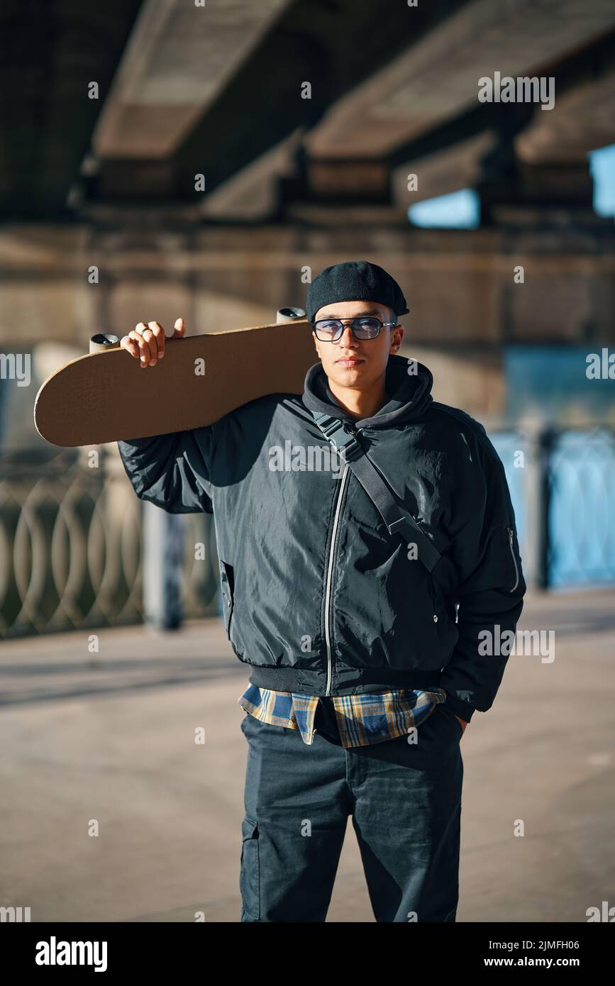 Skater male with skateboard posing on street urban background Stock ...