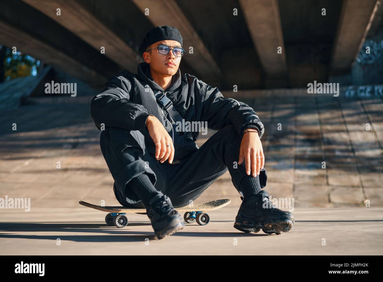 Skater male with skateboard on street urban background Stock Photo - Alamy
