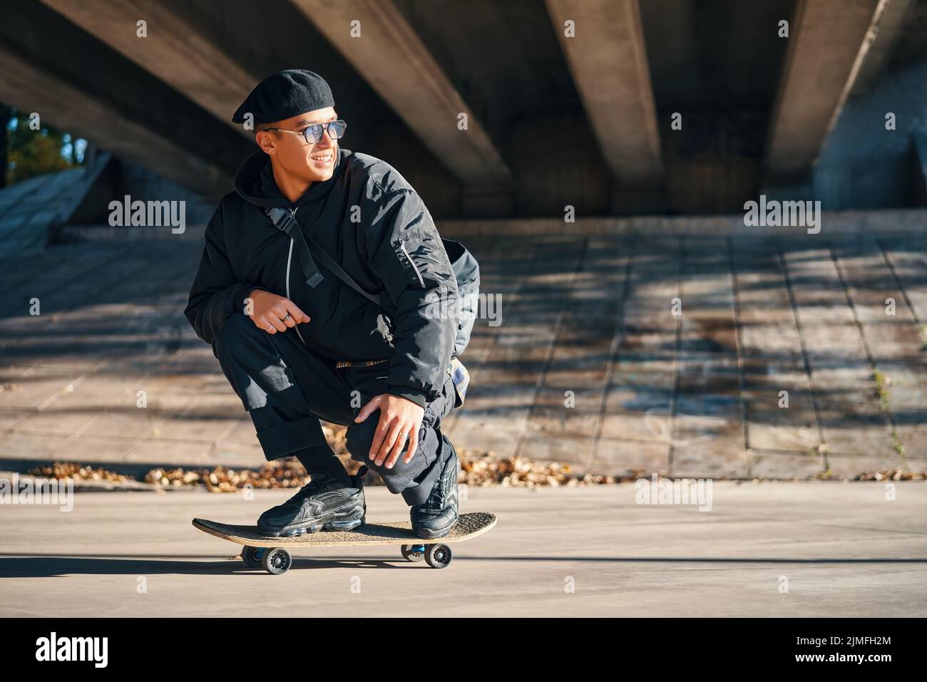 Skater male with skateboard on street urban background Stock Photo - Alamy