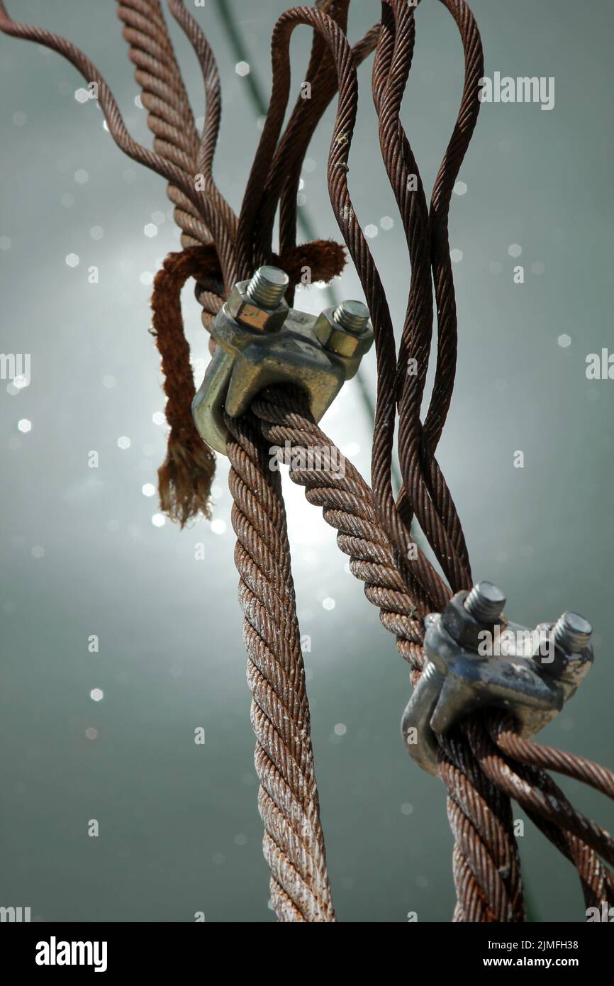 Wire rope clamps and rusty steel ropes Stock Photo - Alamy