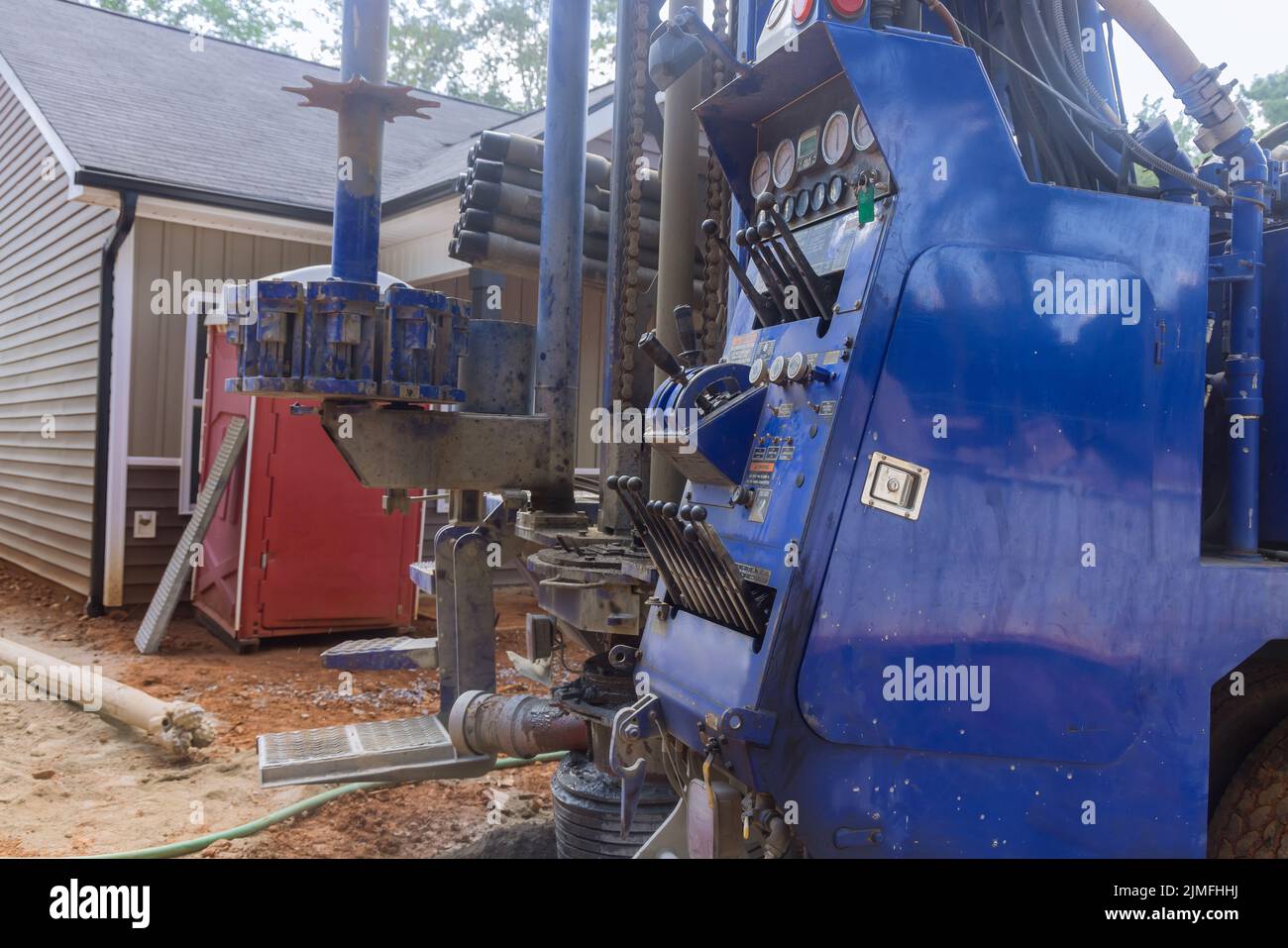 On a private plot of land, a portable hydraulic water well drilling rig ...
