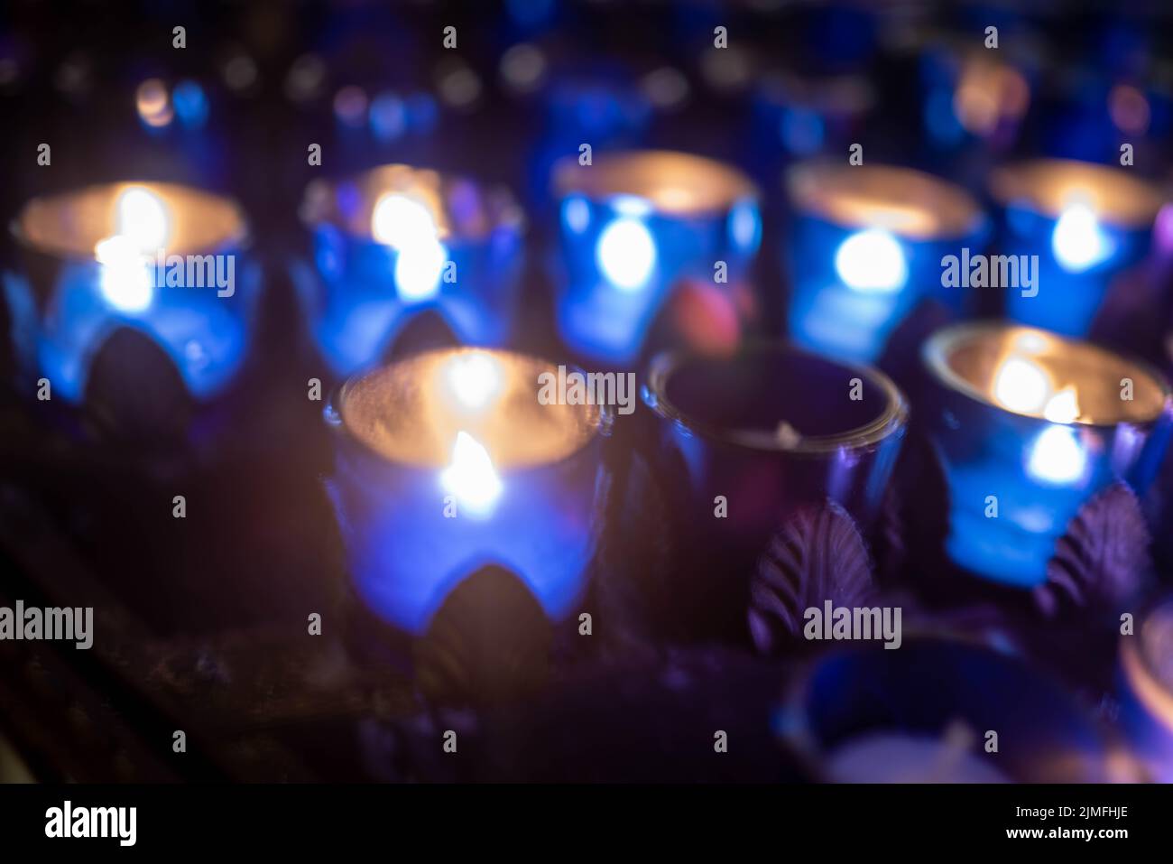 Abstract defocused religious votive candle church interior background ...