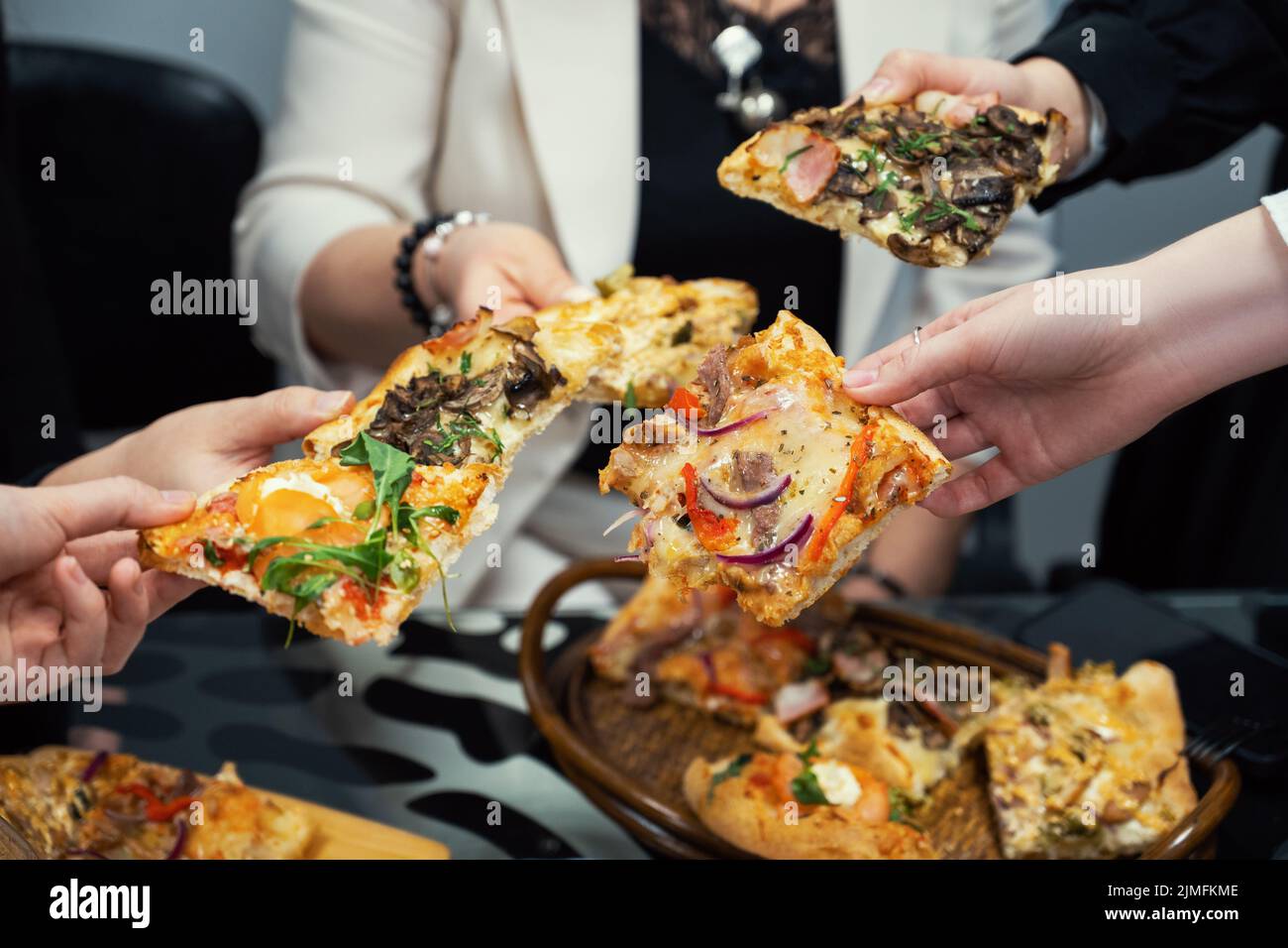 Team people eating pizza Stock Photo - Alamy