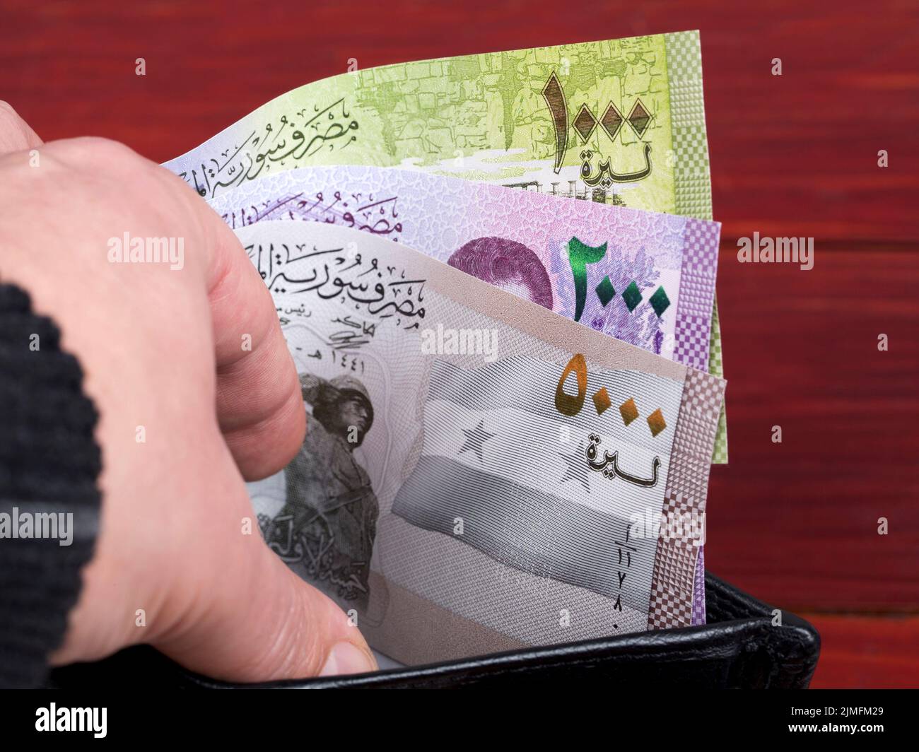 Syrian money in the black wallet Stock Photo - Alamy