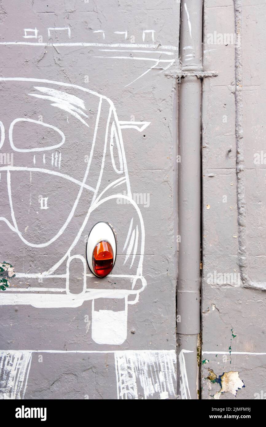 graphic wall painting of VW beetle with rear light on building in ...