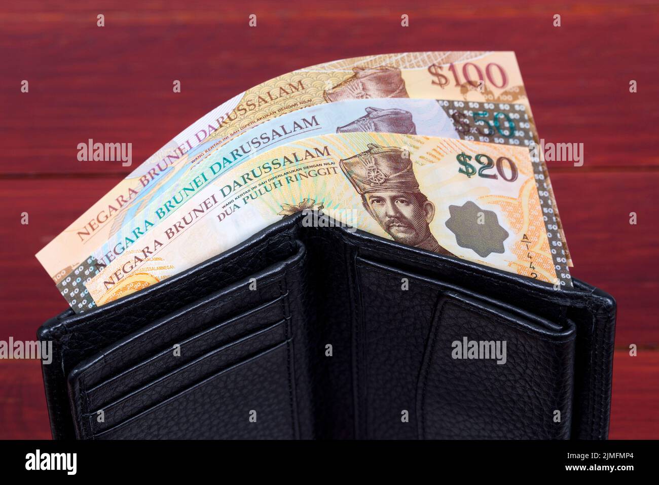 Brunei money in the black wallet Stock Photo - Alamy