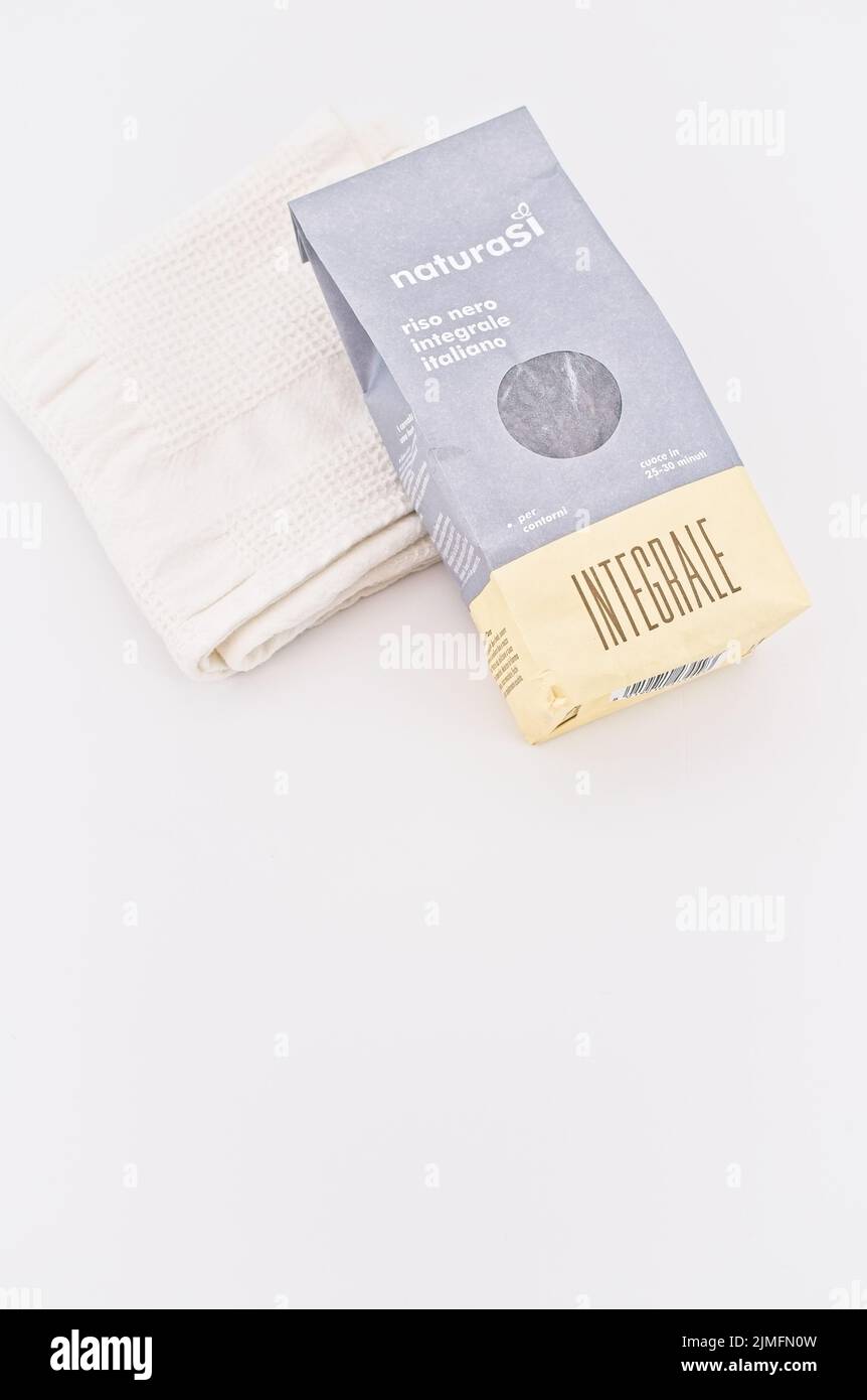 organic farming black rice in a paper bag packaging on a white table ...