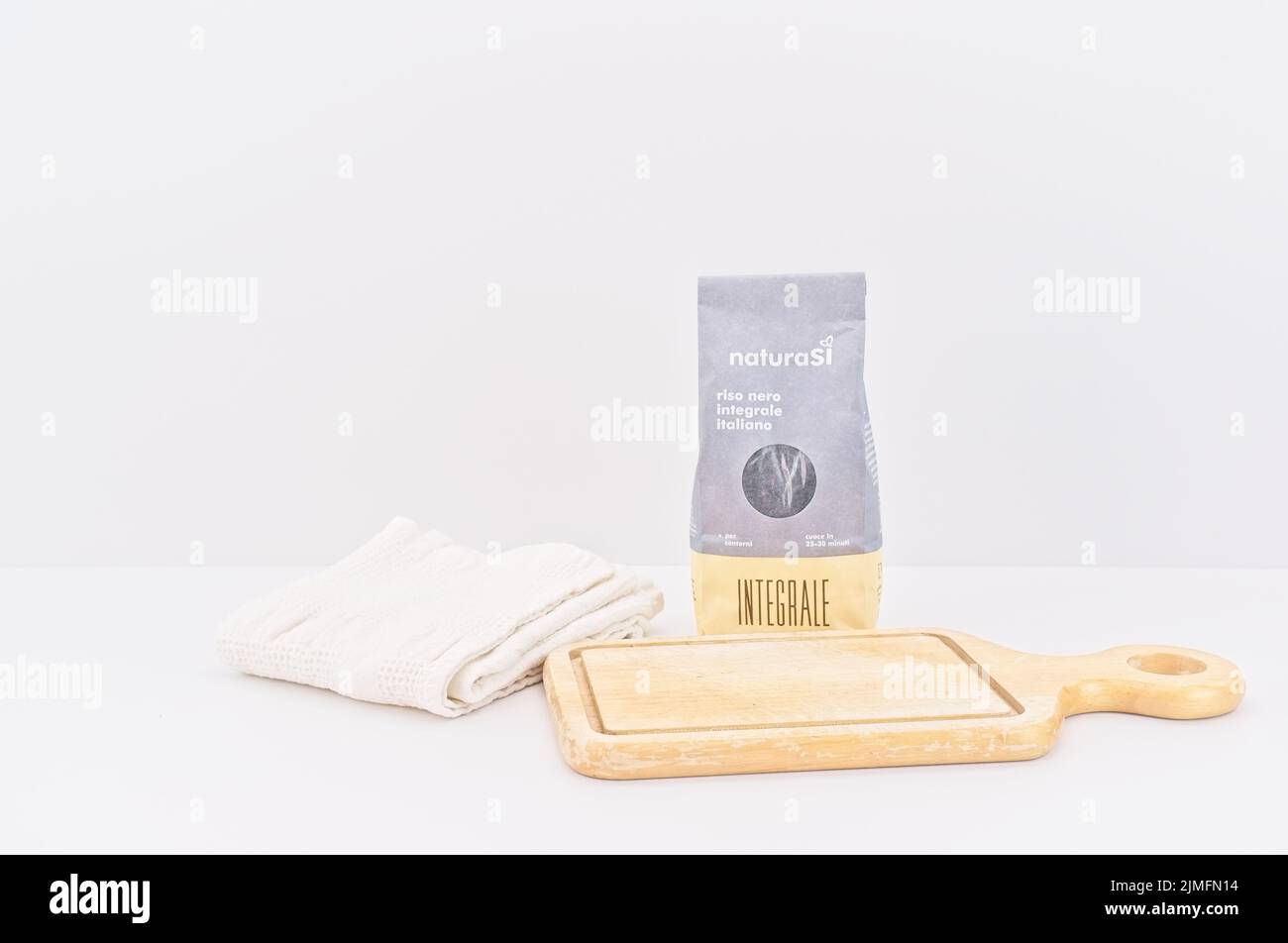 organic farming black rice in a paper bag packaging on a white table ...