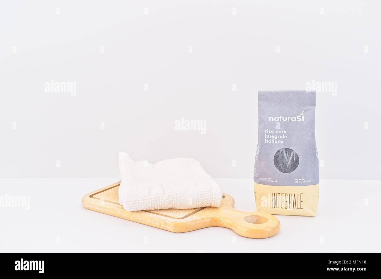 organic farming black rice in a paper bag packaging on a white table ...