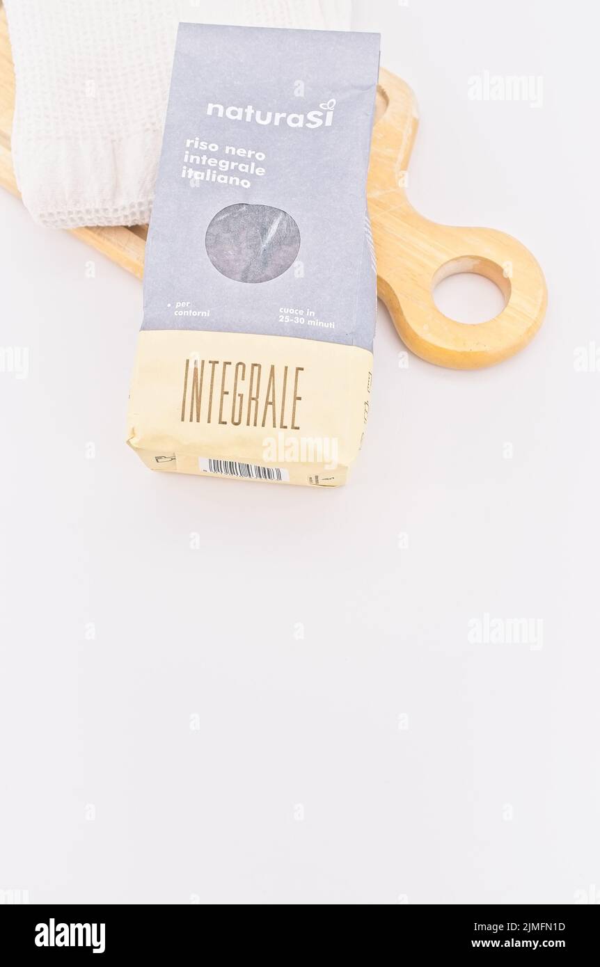 organic farming black rice in a paper bag packaging on a white table ...