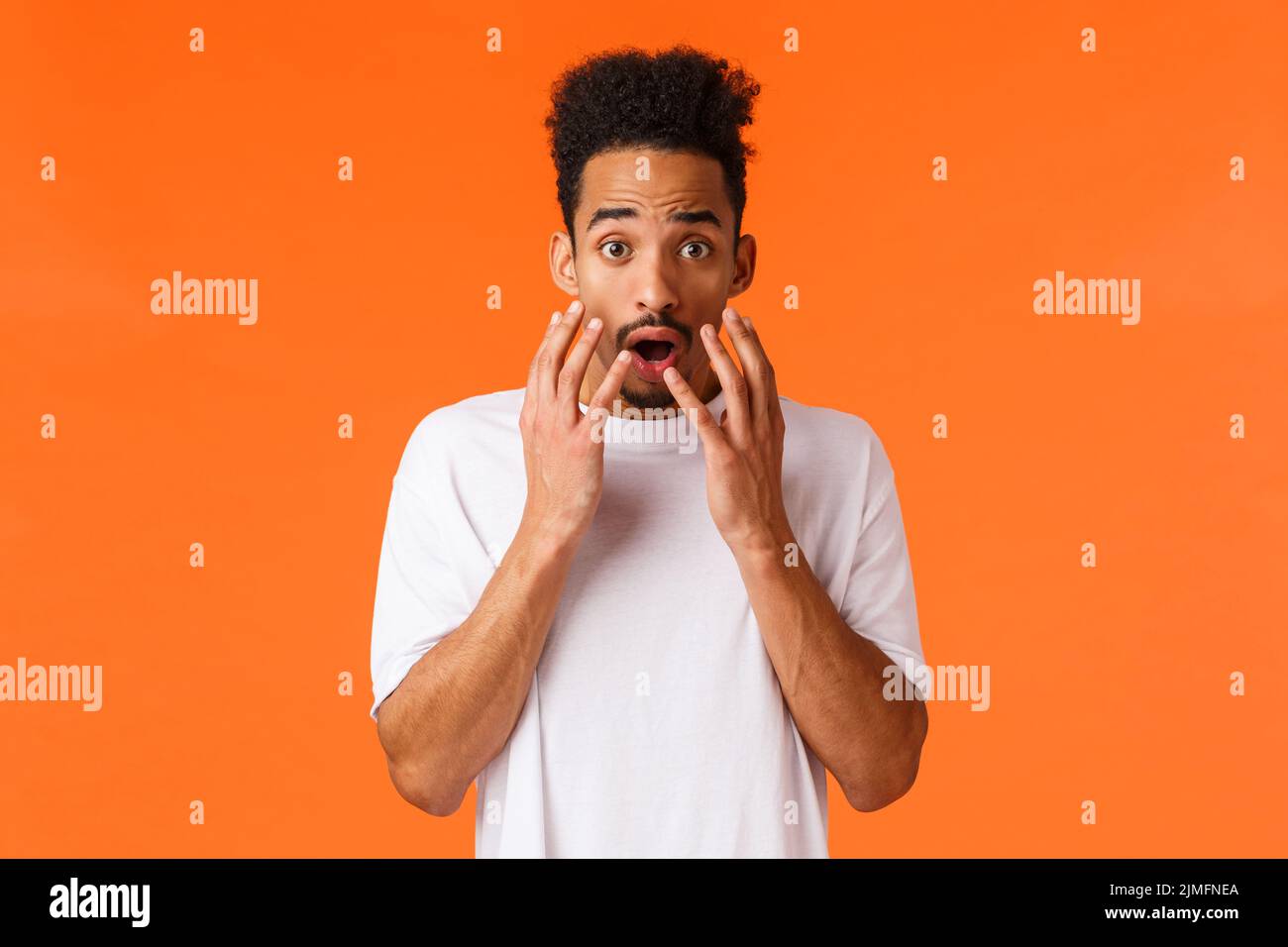 Scared, freaked-out and shocked african-american young hipster guy ...