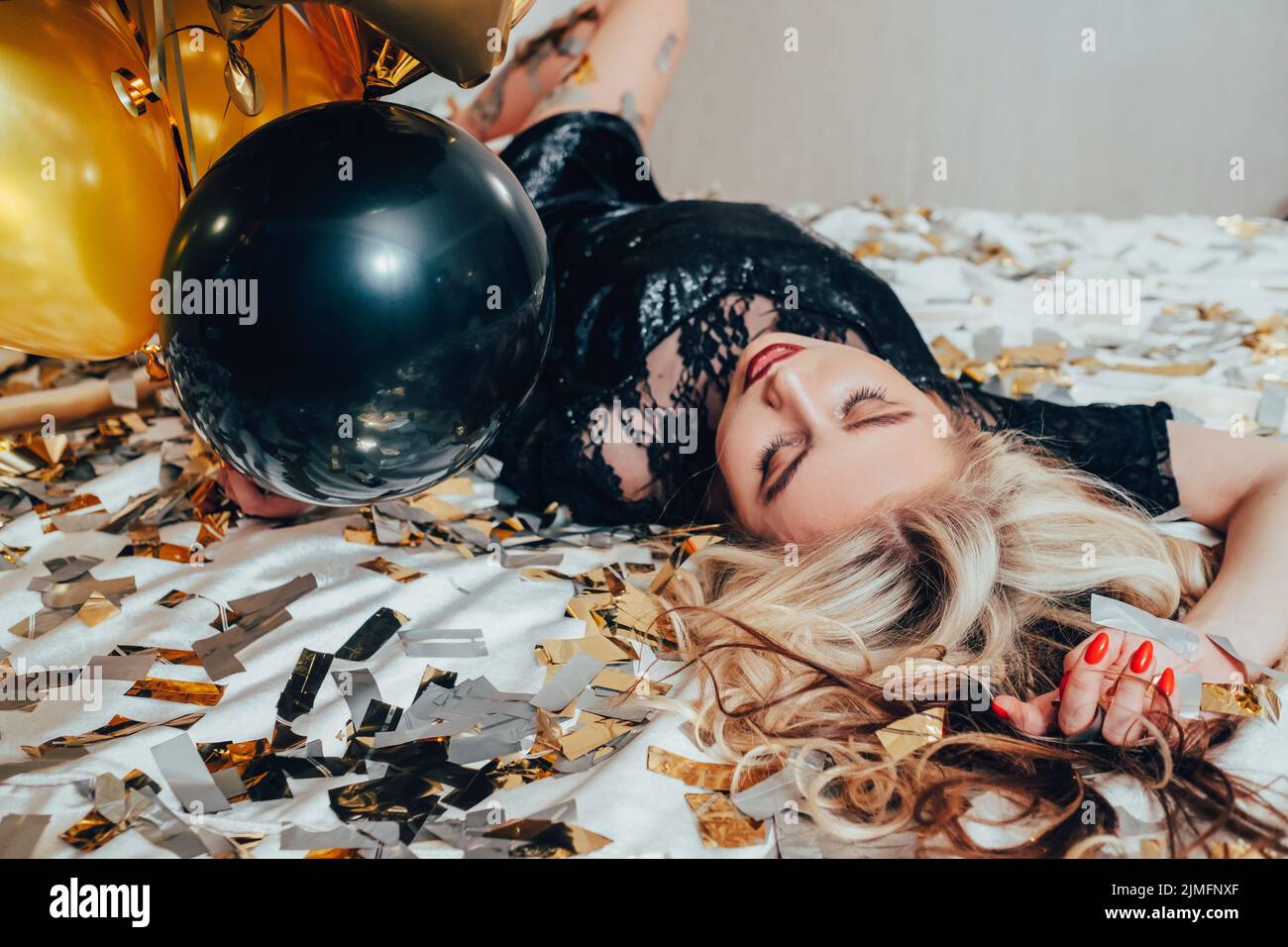 fashion model party relaxation female bed confetti Stock Photo - Alamy