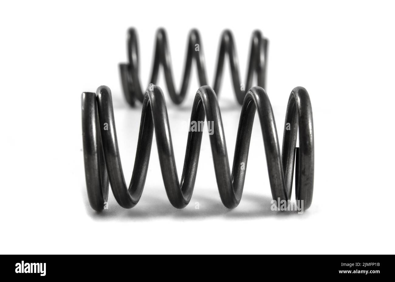 Dark metal spring isolated on white background Stock Photo - Alamy